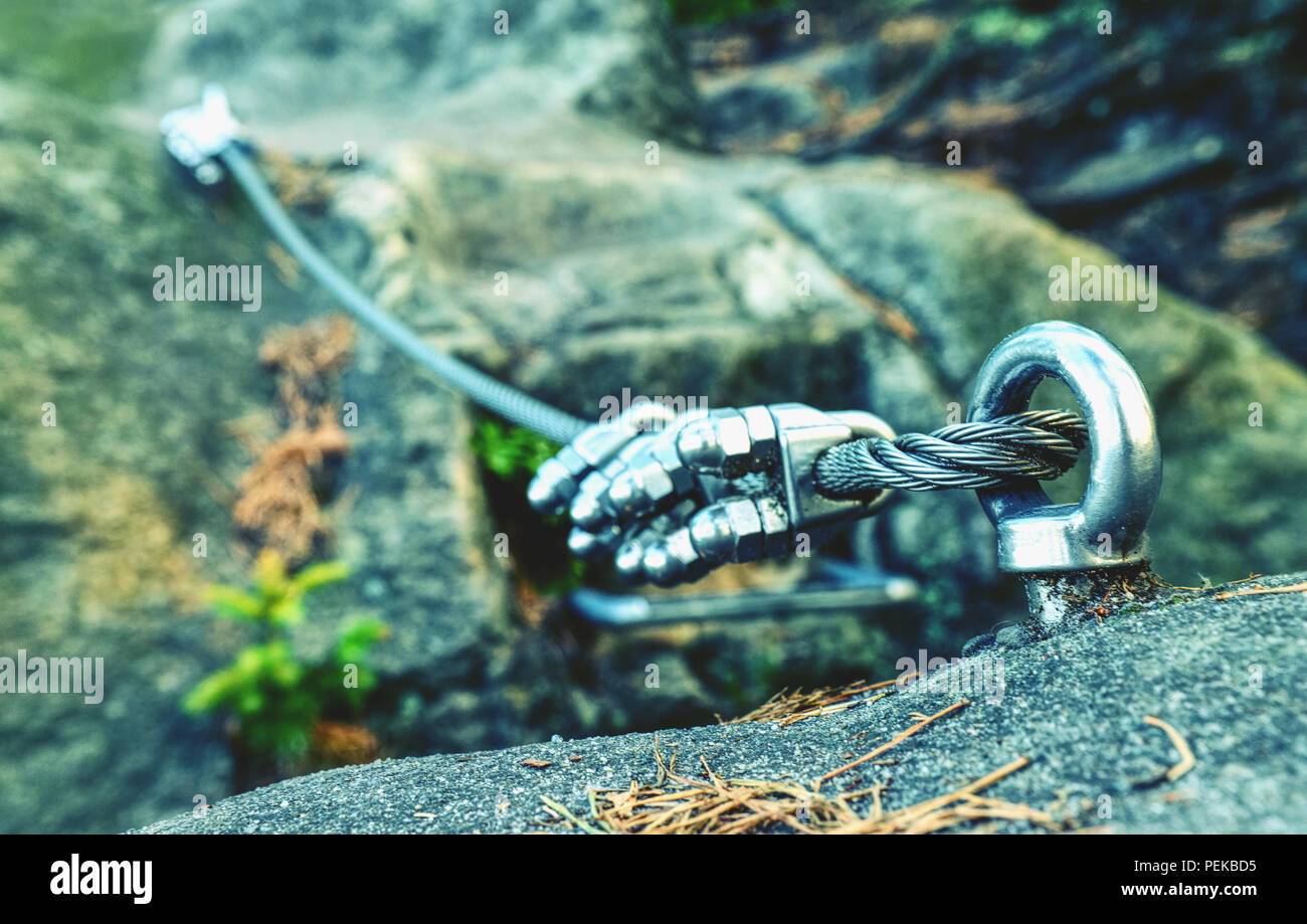 steel fixed rope for via ferrata. Climbing carabiner attached to the ...