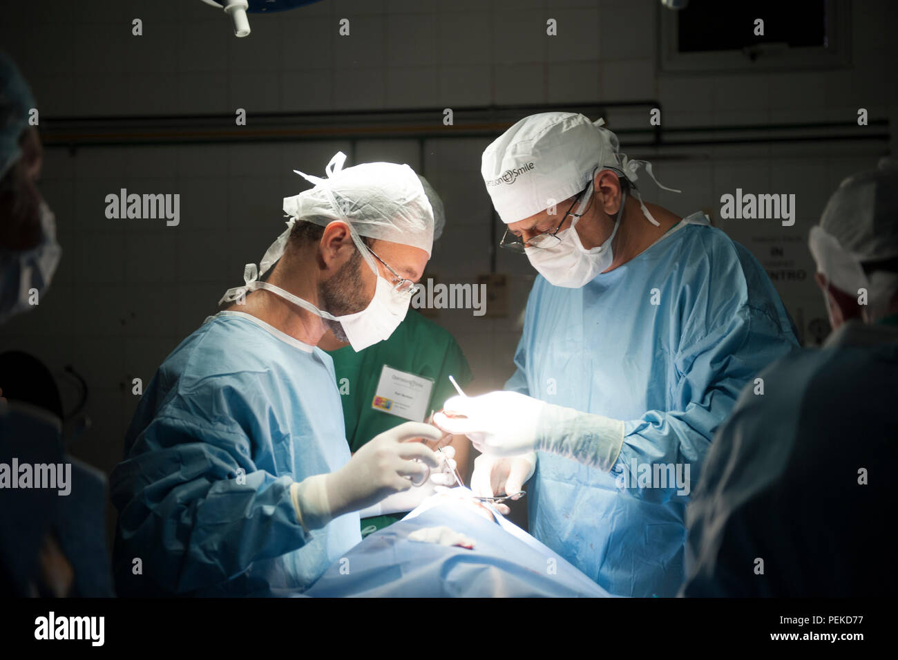 Medical Team Performing Surgical Operation in Bright Modern Operating ...
