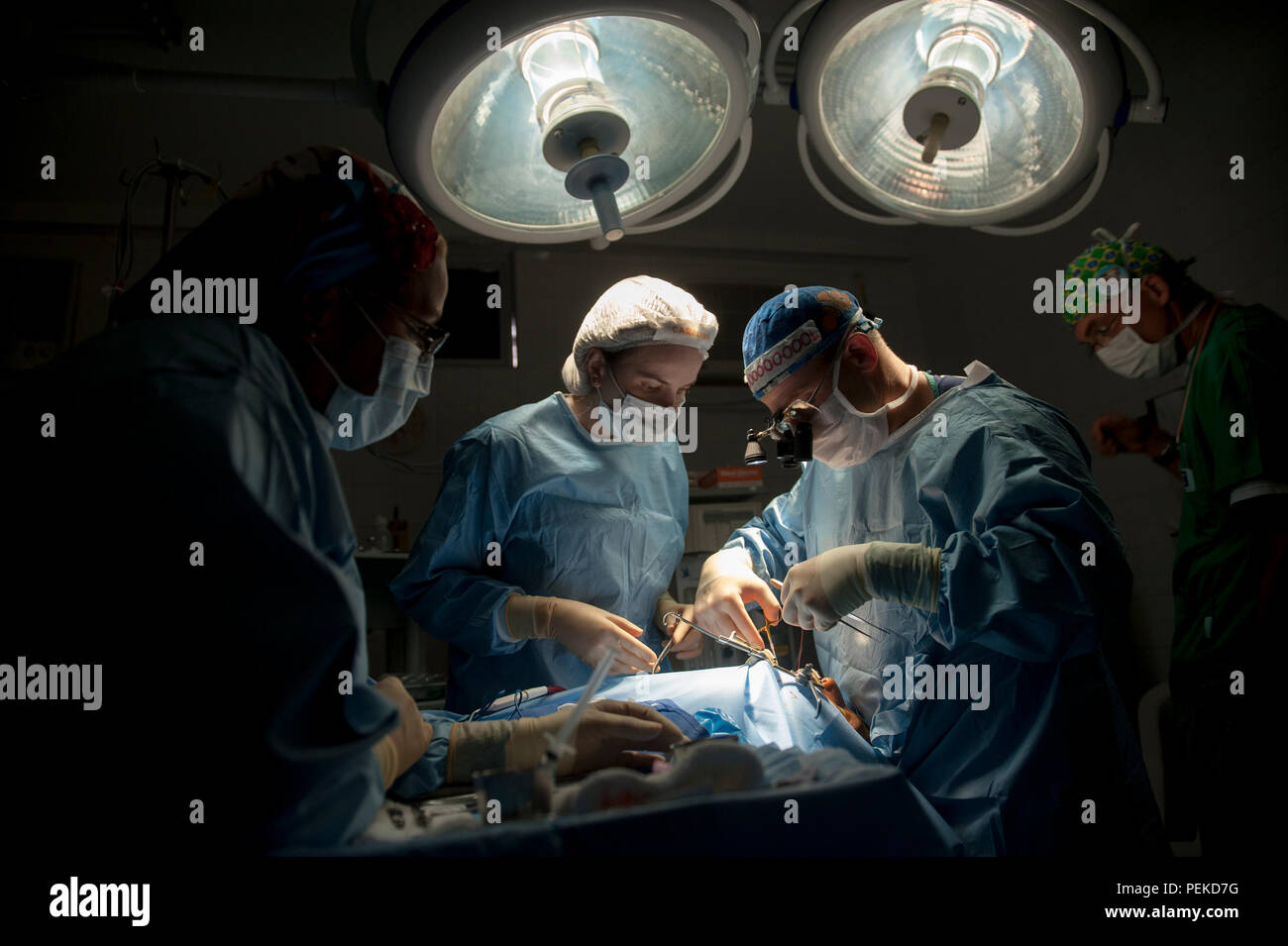 Medical Team Performing Surgical Operation in Bright Modern Operating ...
