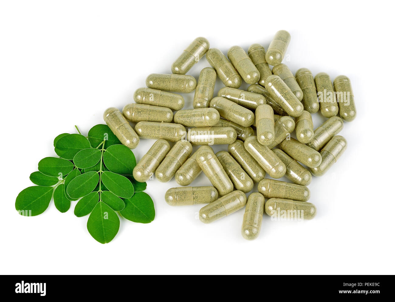 herb capsule with green herbal leaf isolated on white background Stock ...