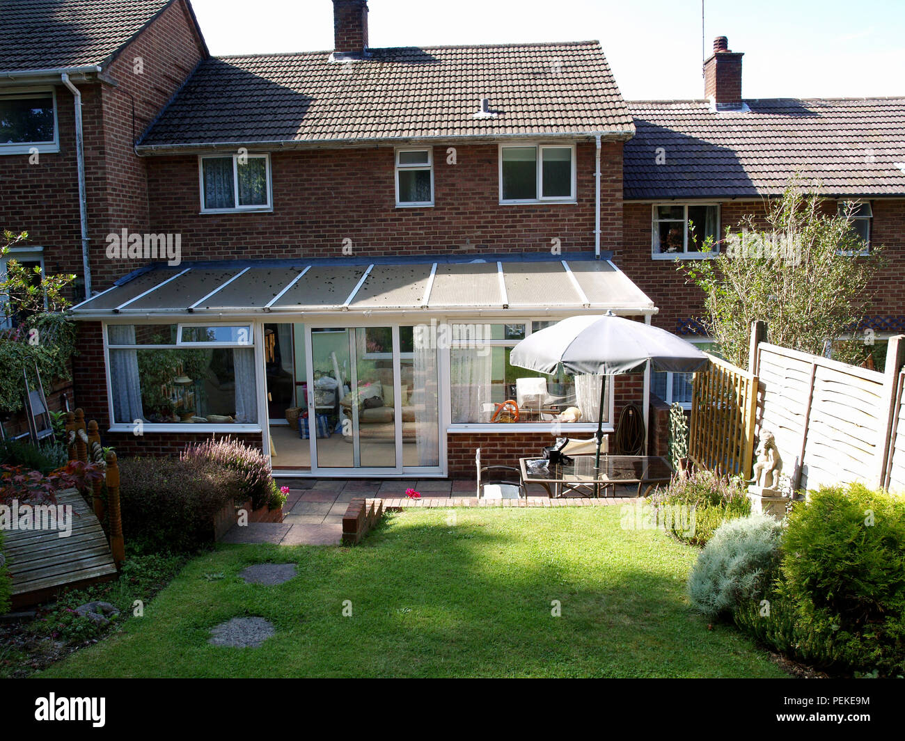 Back garden of English brick built house with conservatory Stock Photo ...