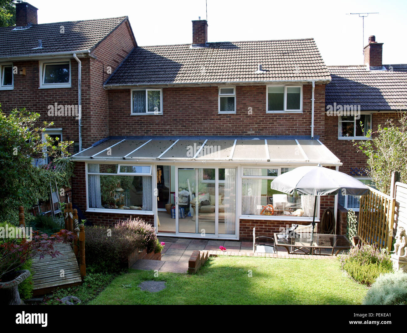 Back garden of English brick built house with conservatory Stock Photo ...