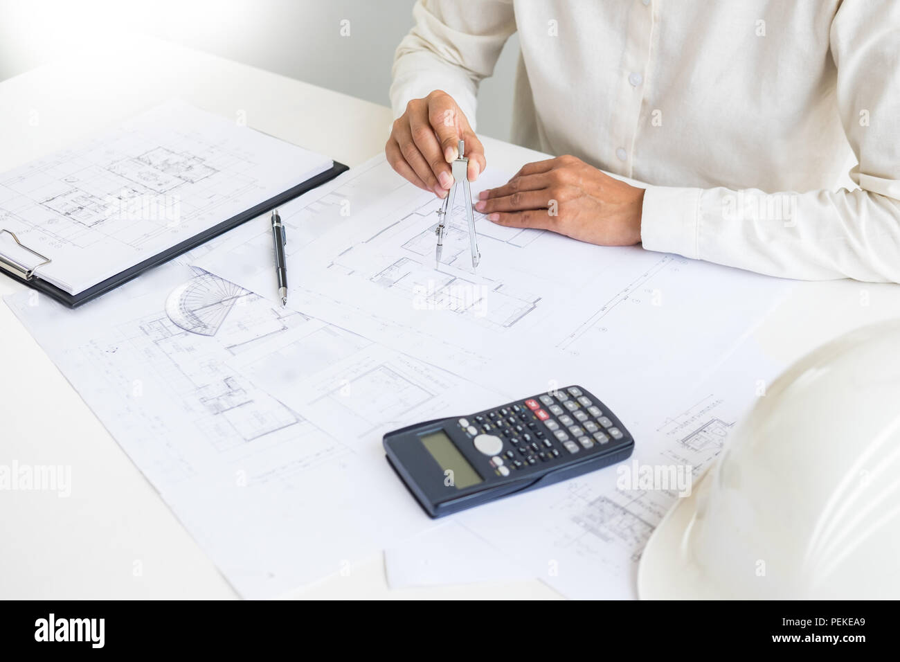 Close-up Of Person's engineer Hand Drawing Plan On Blue Print with ...