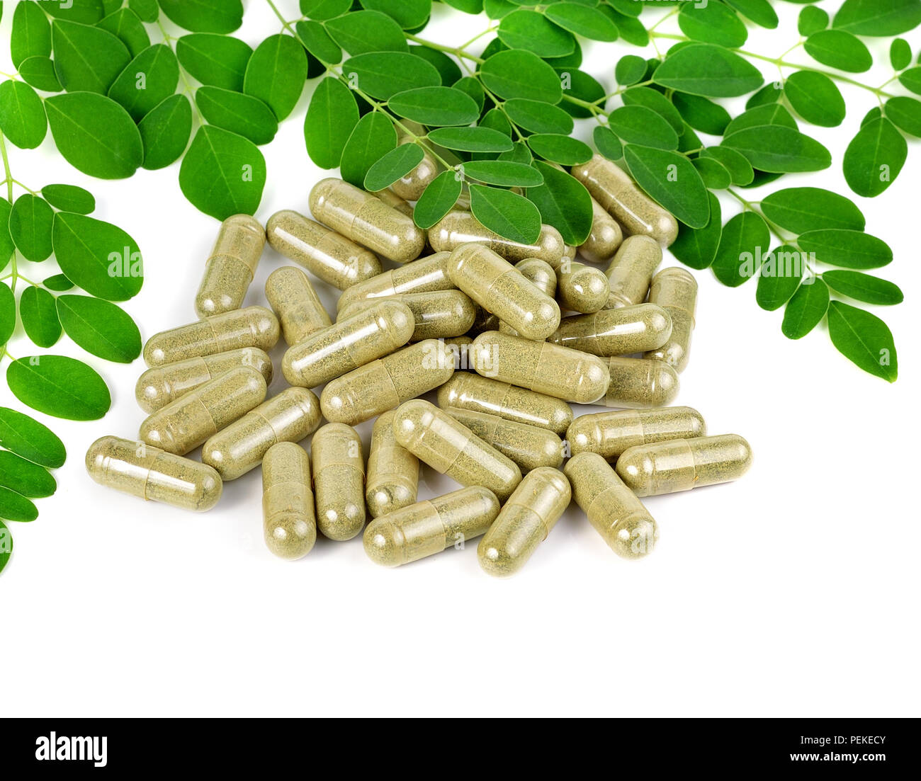 herb capsule with green herbal leaf isolated on white background Stock ...