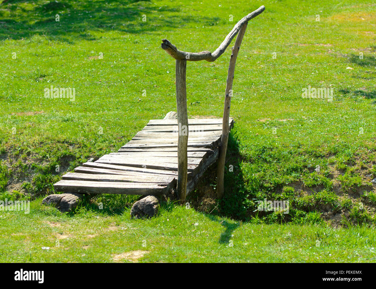 Deformed and dilapidated old wooden bridge over the canal, the concept ...