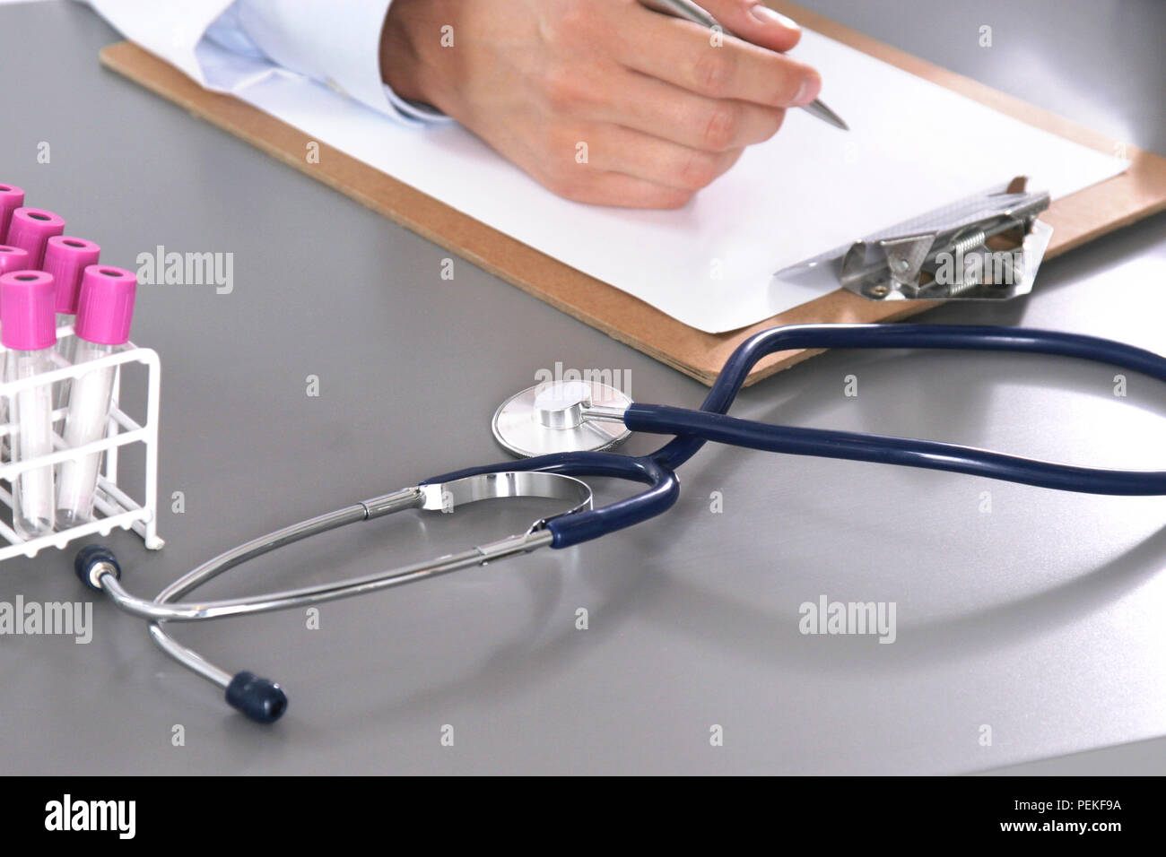 Male doctor write on the desk with test tube Stock Photo - Alamy