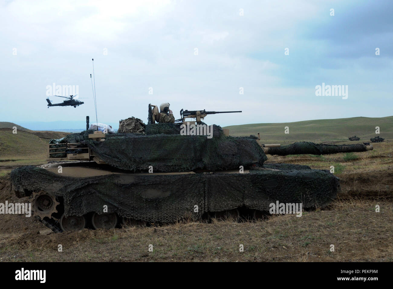 A 12th Combat Aviation Brigade AH-64 Apache attack helicopter and a ...