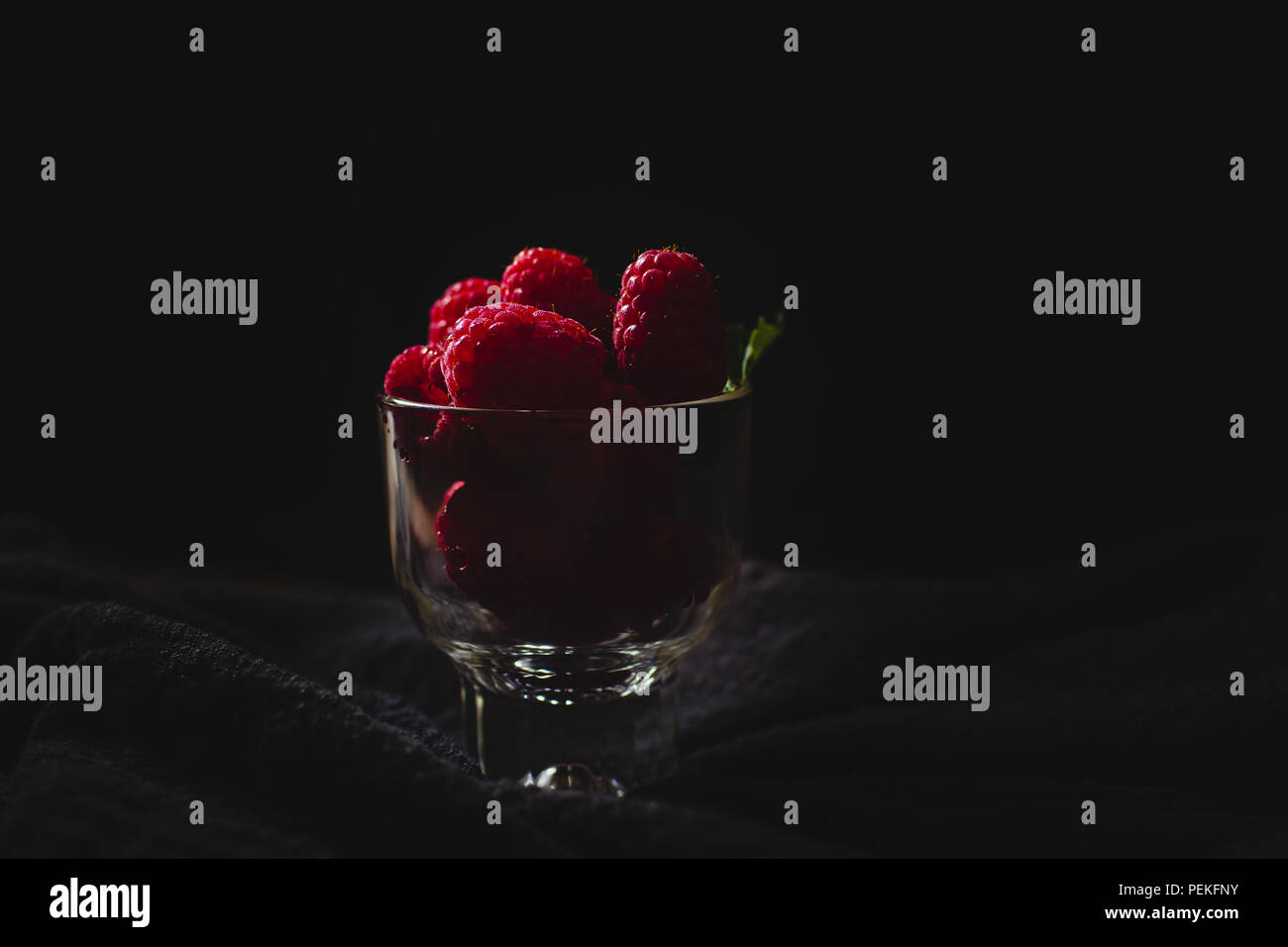 Raspberries in Dark Moody Background Stock Photo - Alamy