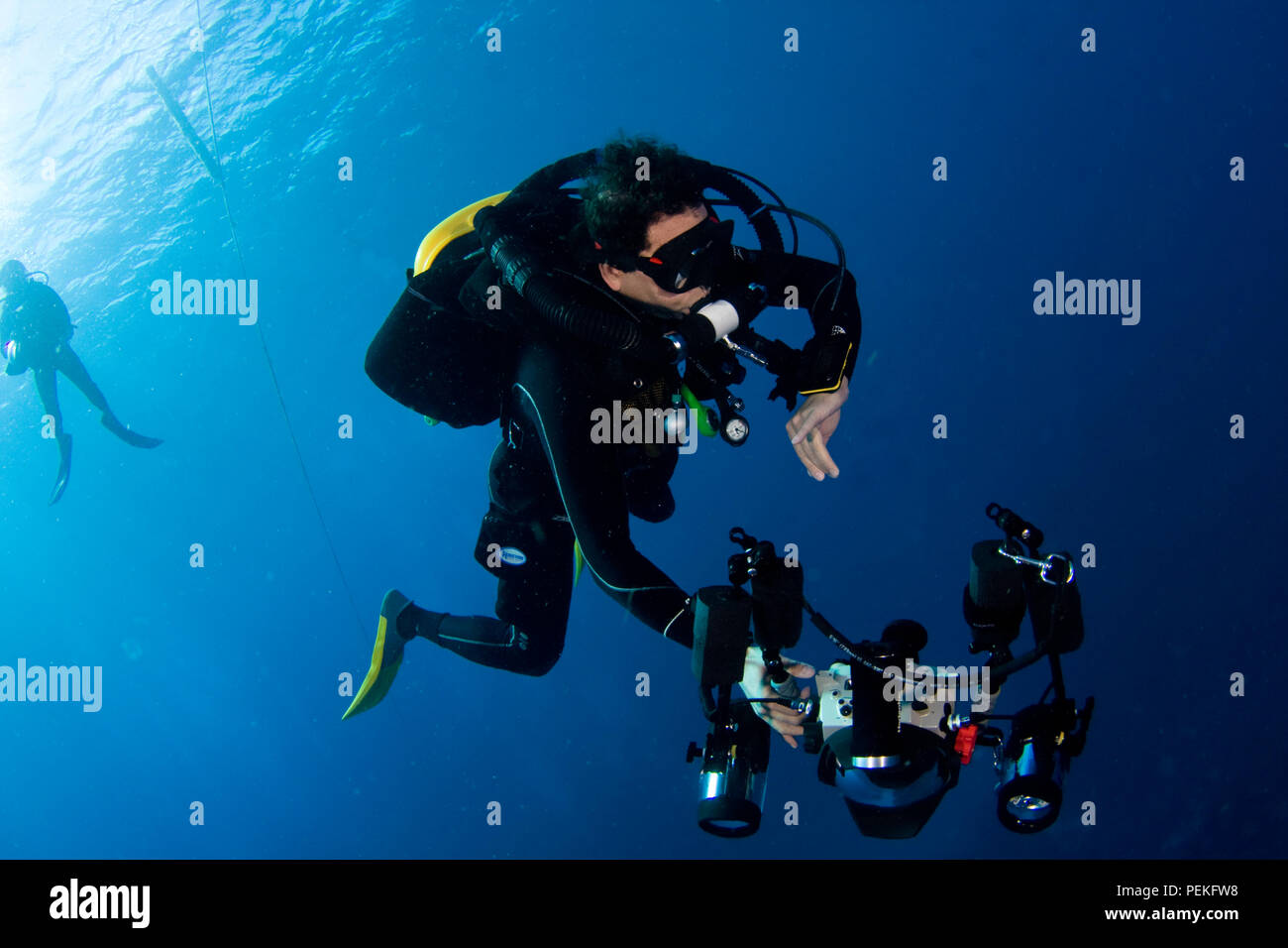 Rebreather diver checking gauges off the island of Bonaire, Caribbean ...