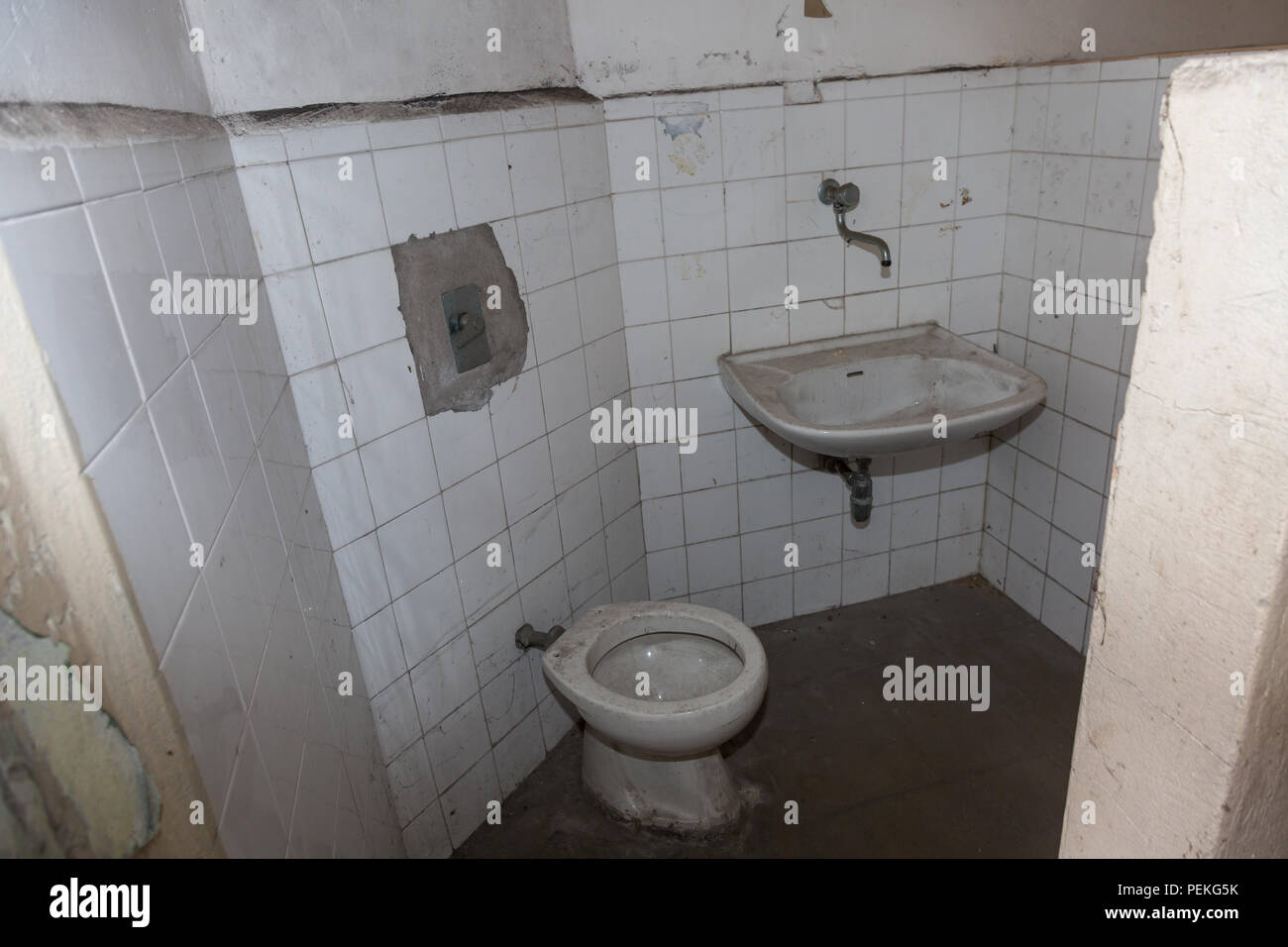 Empty Room with a Toilet in an Old Prison Stock Photo - Alamy