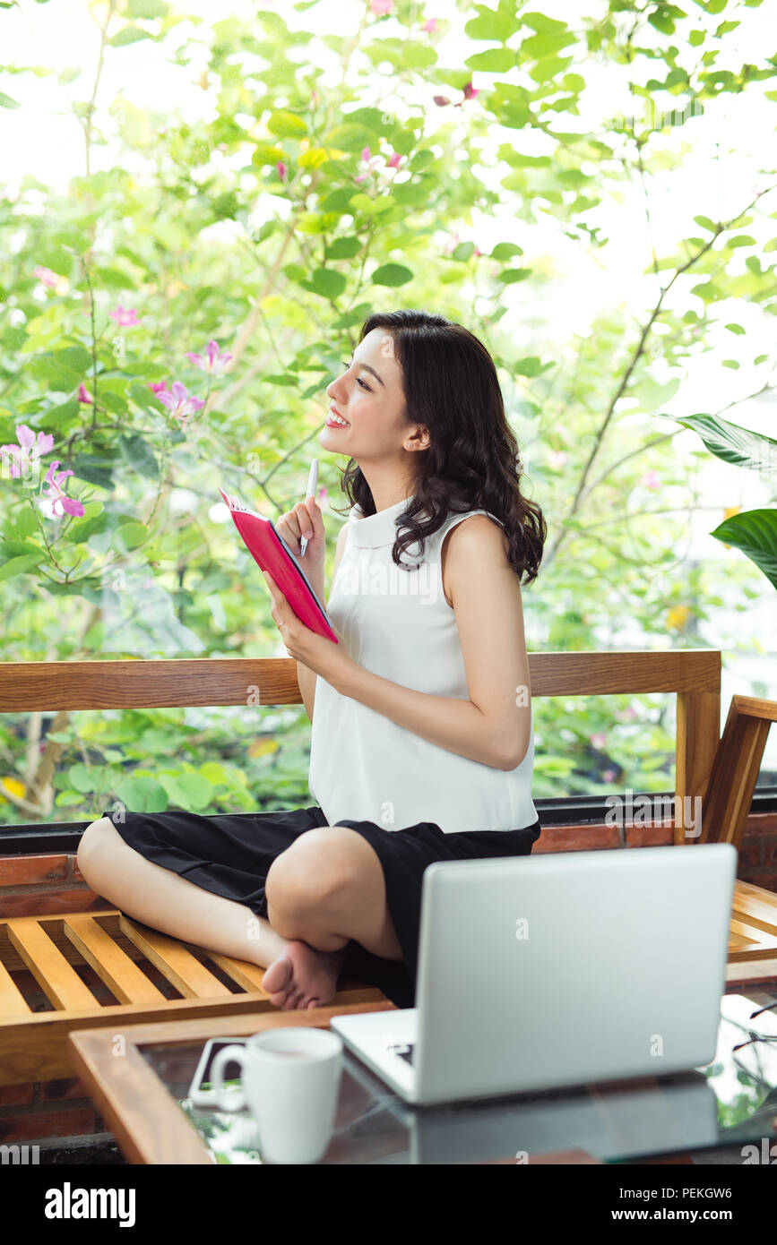 Beautiful asian girl writing notes in a desk at home Stock Photo - Alamy