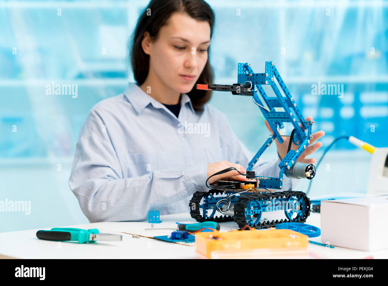 Student girl in electronics laboratory, experiment with microcontroller ...