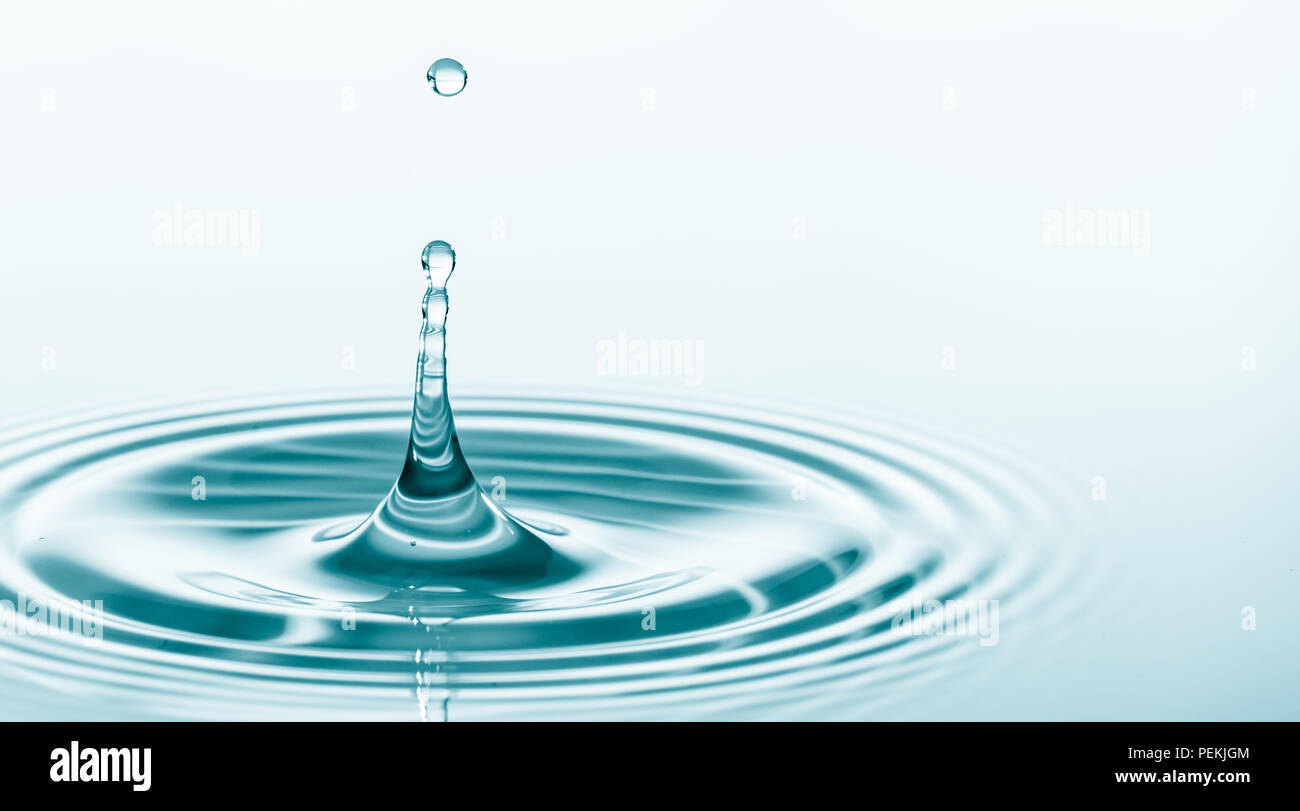 Water drop falling into water making a perfect droplet splash Stock ...