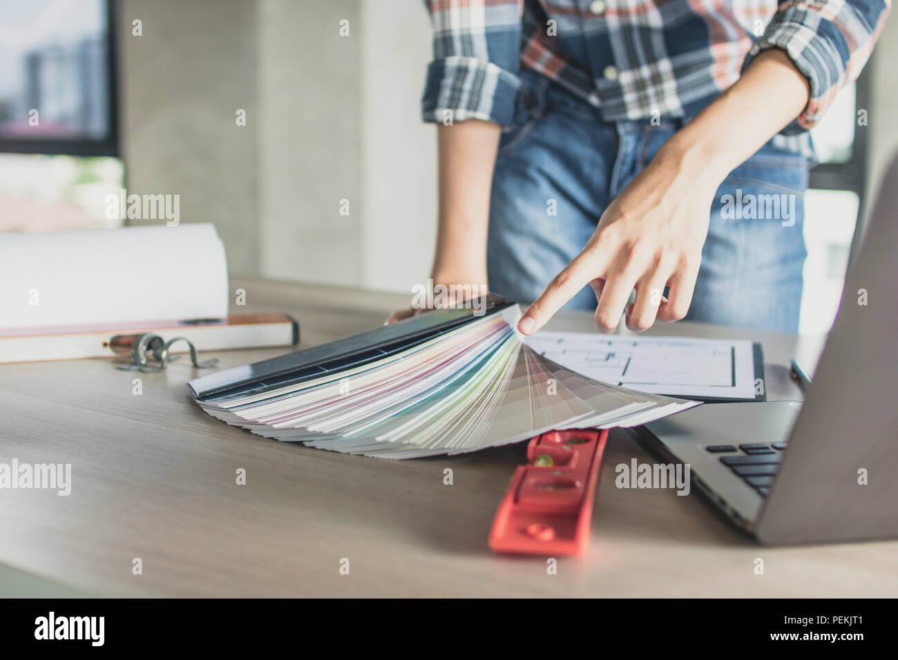 engineer checking color in coloring chart and looking on laptop in ...