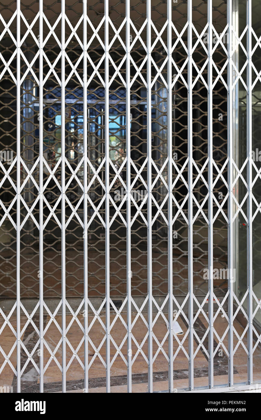 Closed expanding security gate in bank Stock Photo - Alamy