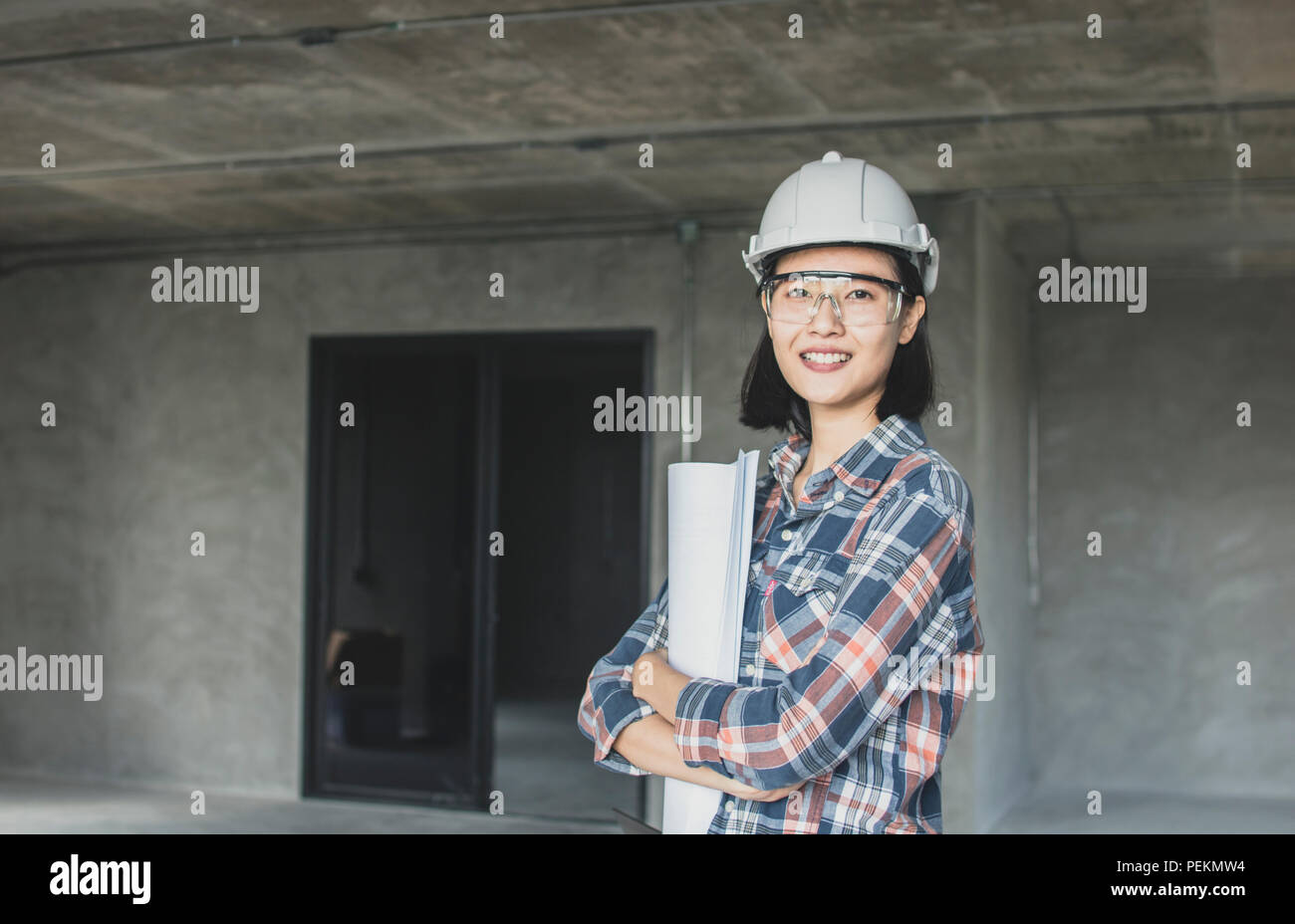 portrait of engineering women holding blueprint at construction site ...