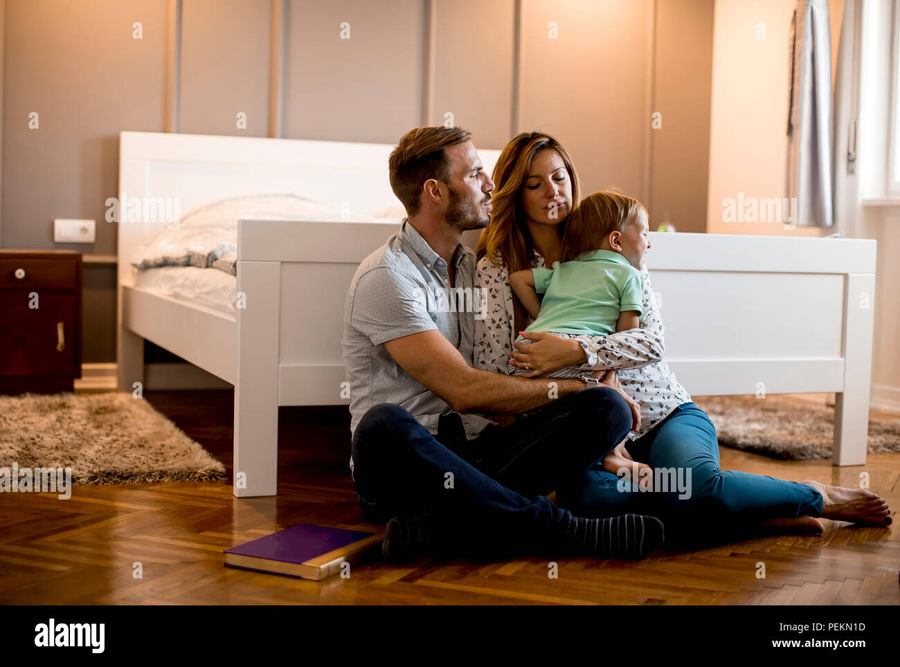 Young happy family hugging in the room Stock Photo - Alamy