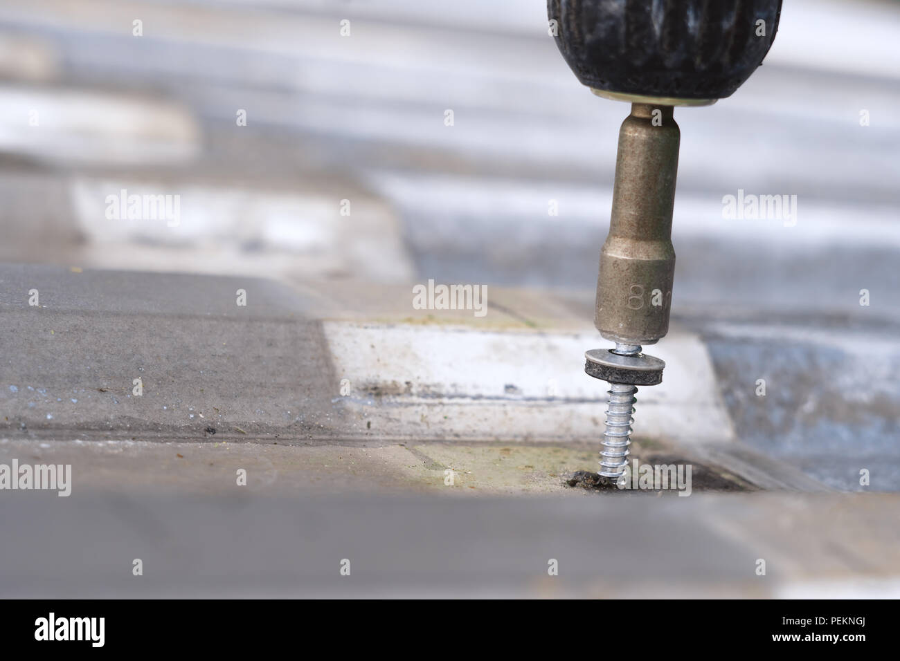 tightening screw roofing iron roof Stock Photo - Alamy