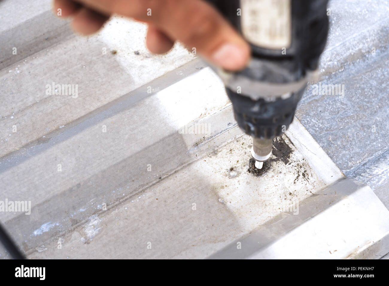 tightening screw roofing iron roof Stock Photo - Alamy