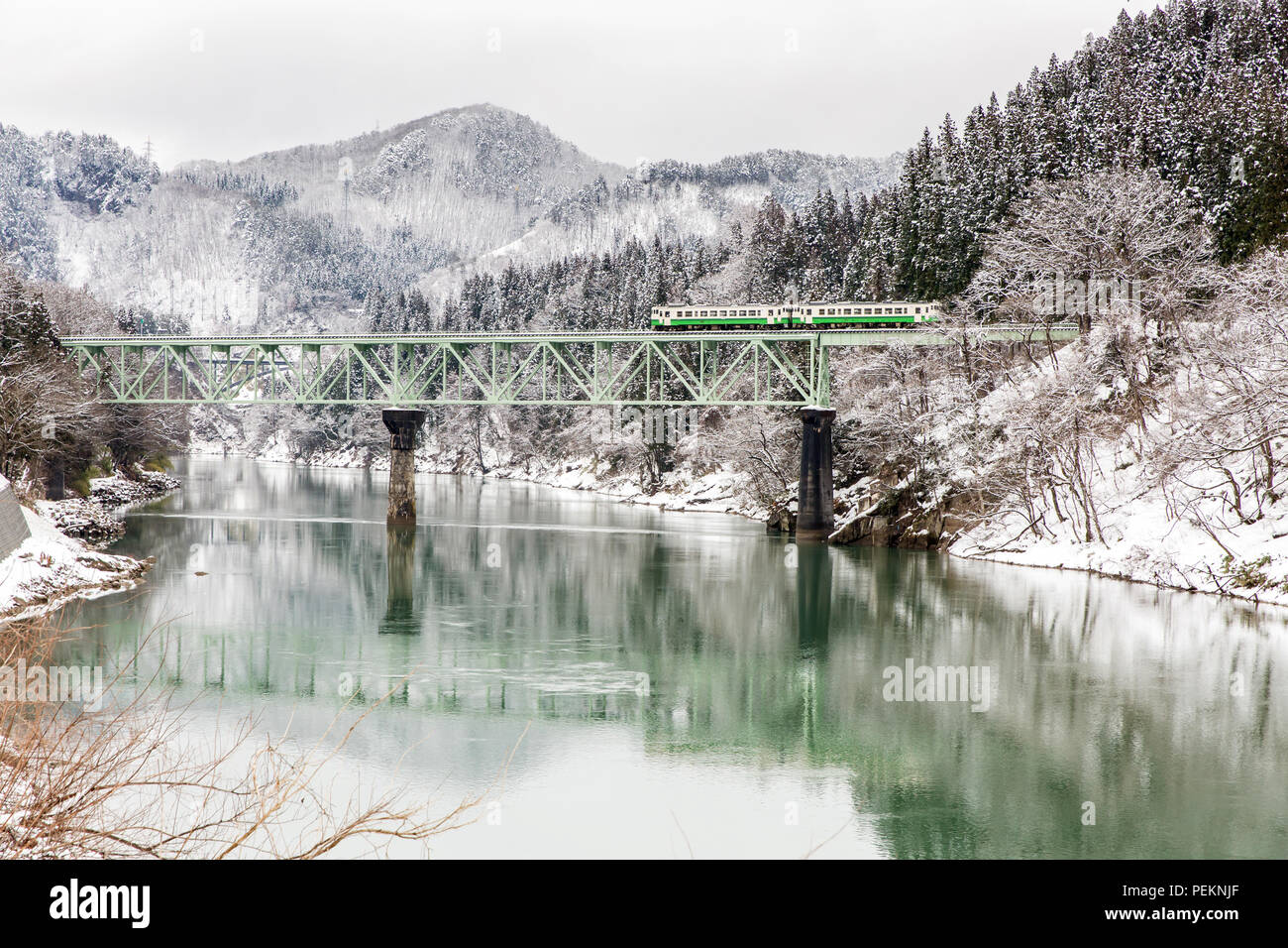 Train in Winter landscape snow on bridge Stock Photo - Alamy