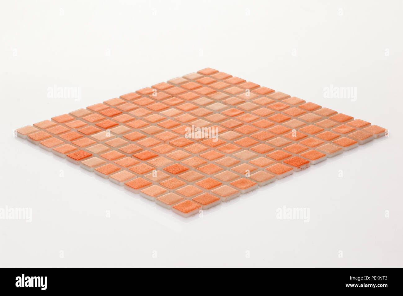 little orange ceramic tile on a white background, majolica. for the ...