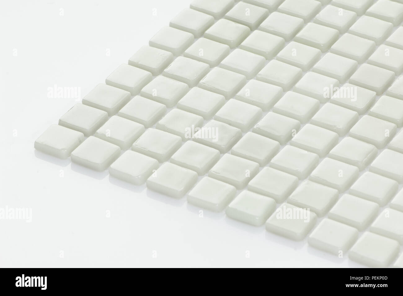 little white ceramic tile on a light background, majolica. for the ...