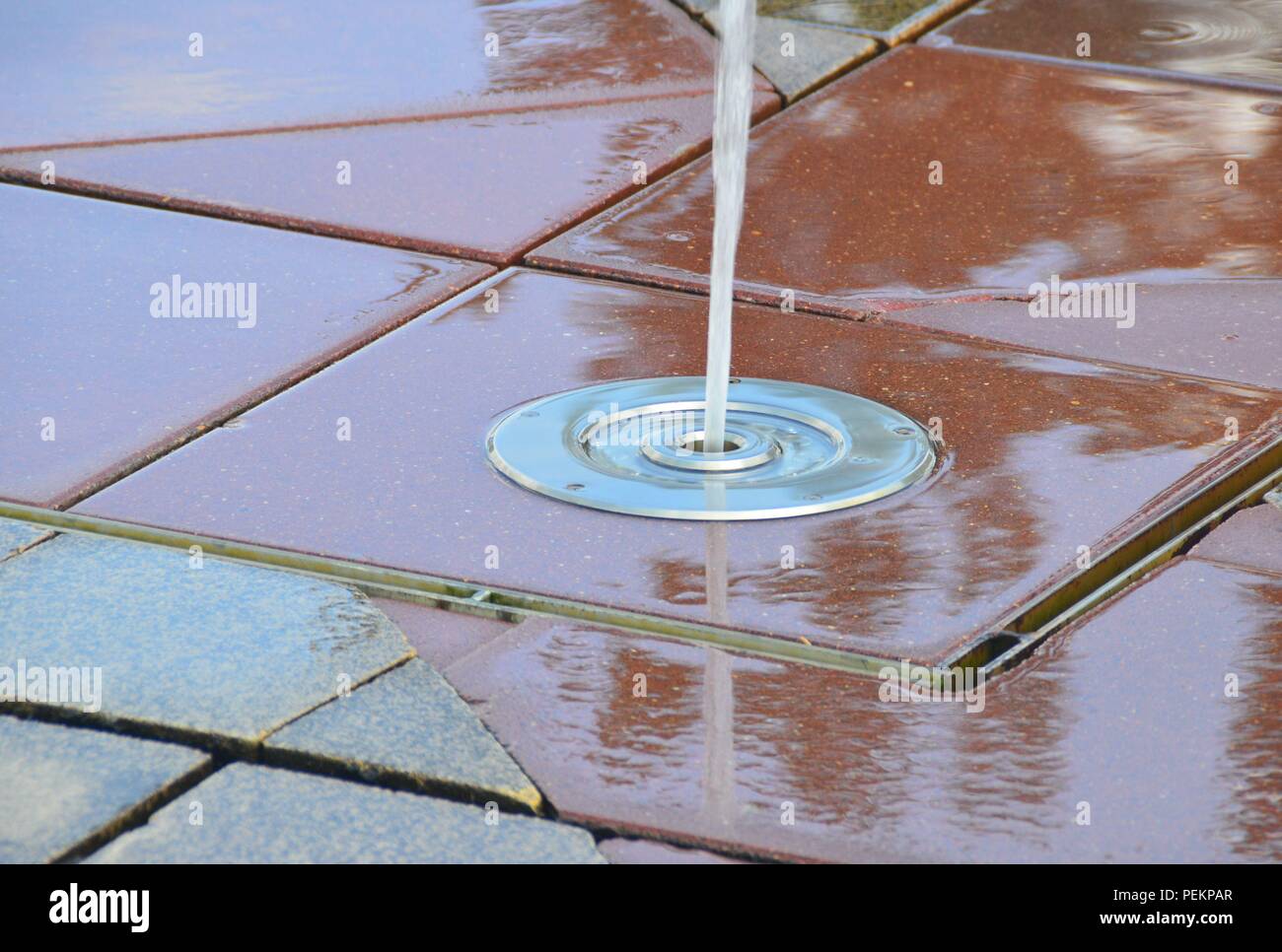 Fountain in cobblestone Stock Photo - Alamy