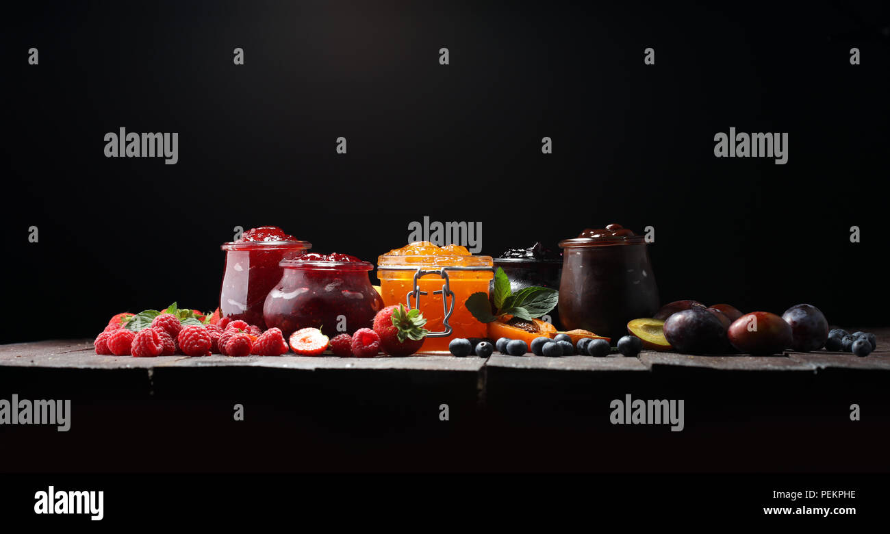 assortment of jams, seasonal berries, apricot, mint and fruits ...
