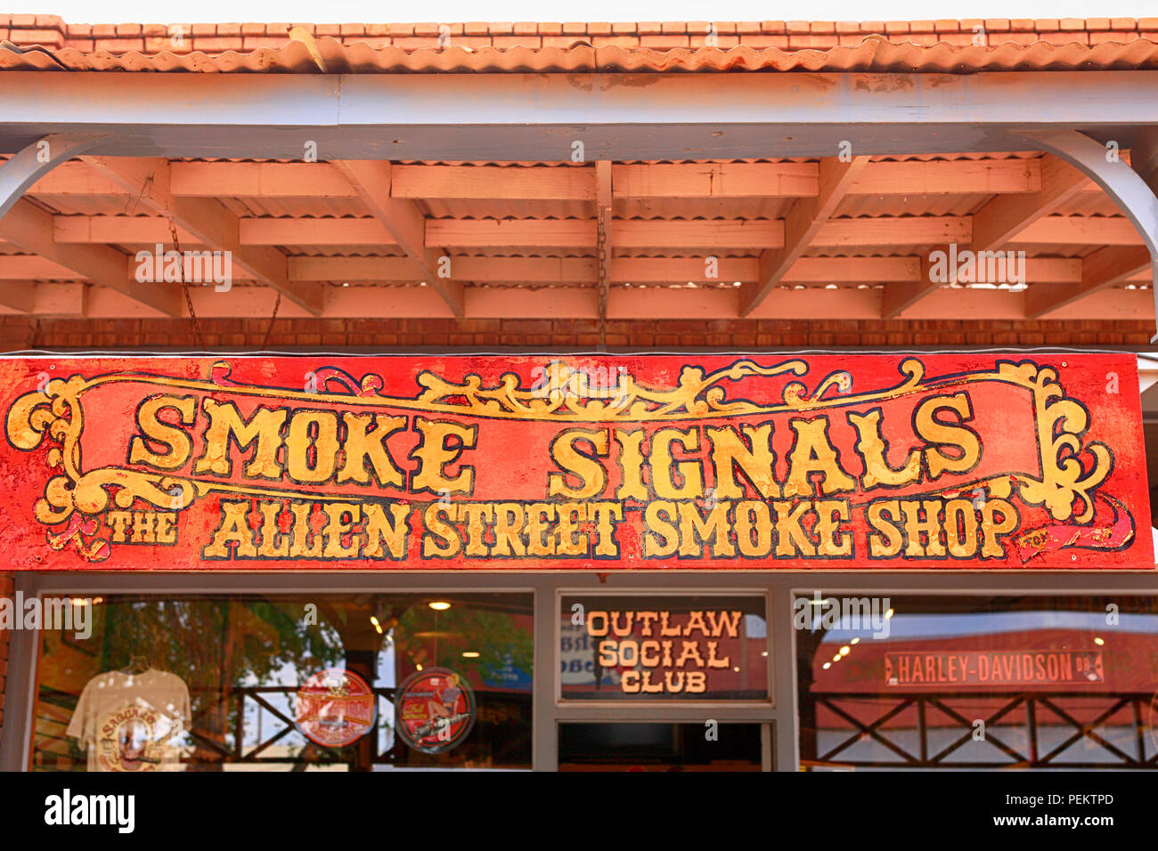 Smoke Signals overhead sign at the smoke shop and Outlaw Social Clun on ...