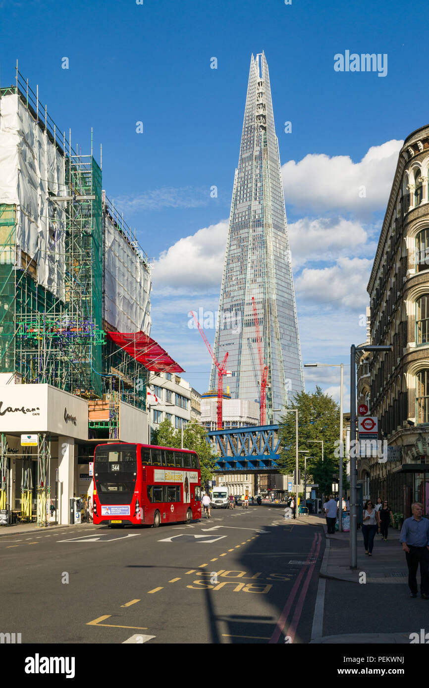 Southwark street with people and traffic, with the Shard skyscraper ...