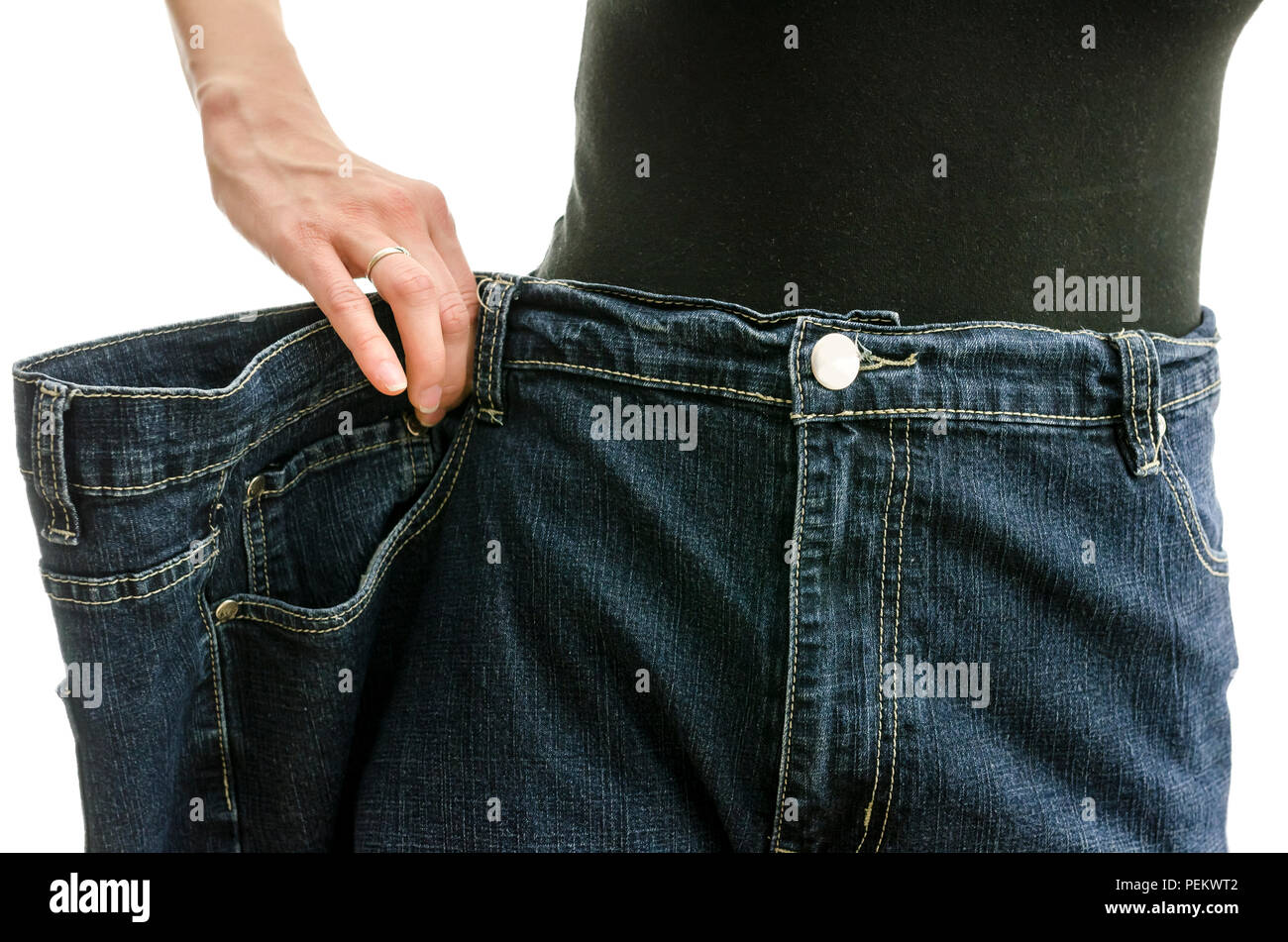 Closeup of a slim woman waist in oversized pants after losing a lot of ...