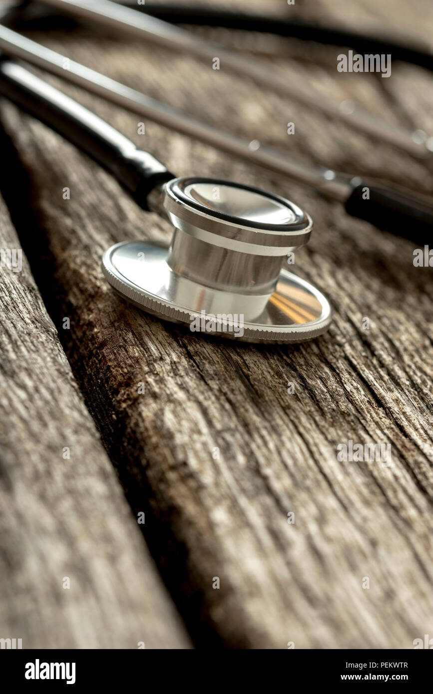 Closeup of stethoscope disc on an old rustic wooden desk Stock Photo ...