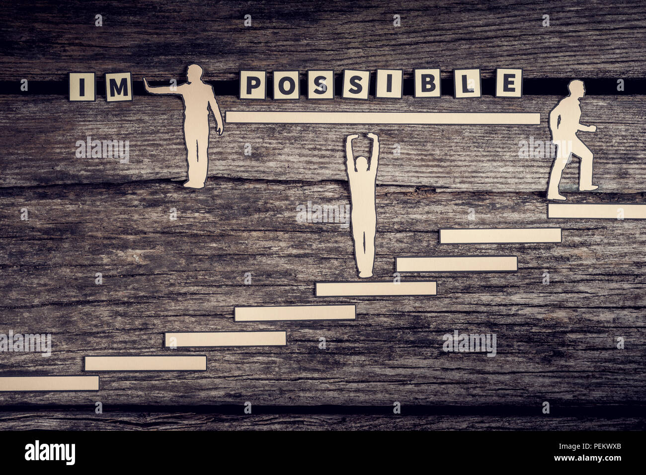 Conceptual possible - impossible letter tiles sign with person walking ...