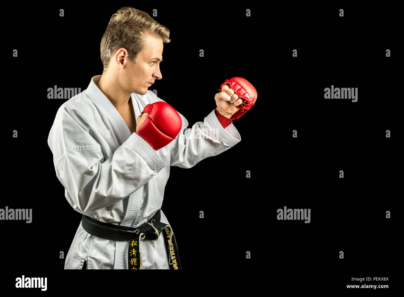 Kick box fighter in action pose. Isolated over black background Stock ...
