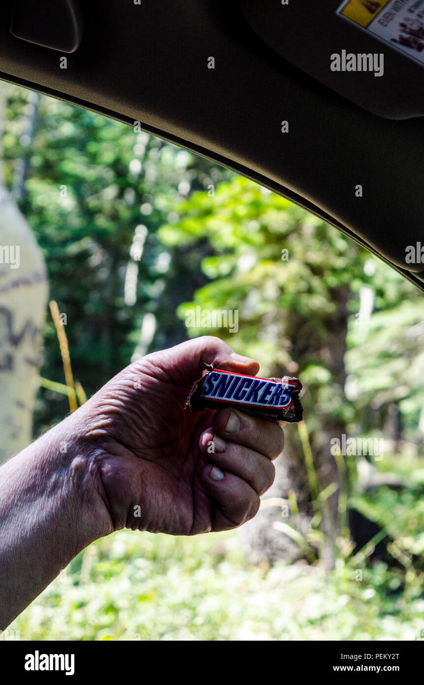 Hand holding snickers hi-res stock photography and images - Alamy