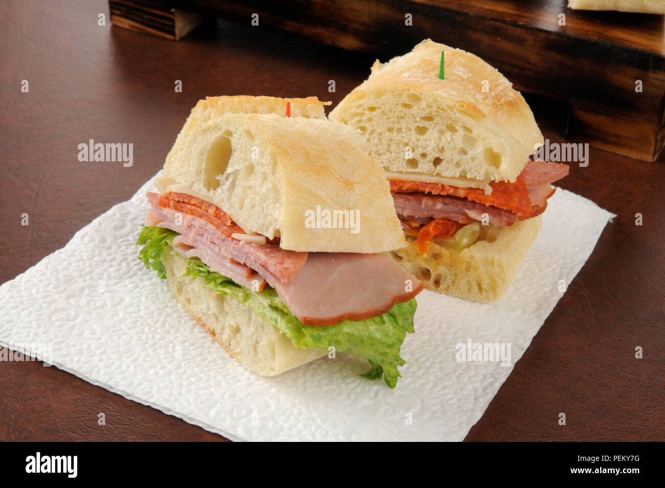 A sliced submarine sandwich with Italian cold cuts on ciabatta bread ...