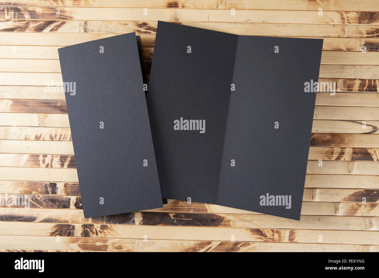 Mockup of black booklet on bamboo background Stock Photo - Alamy
