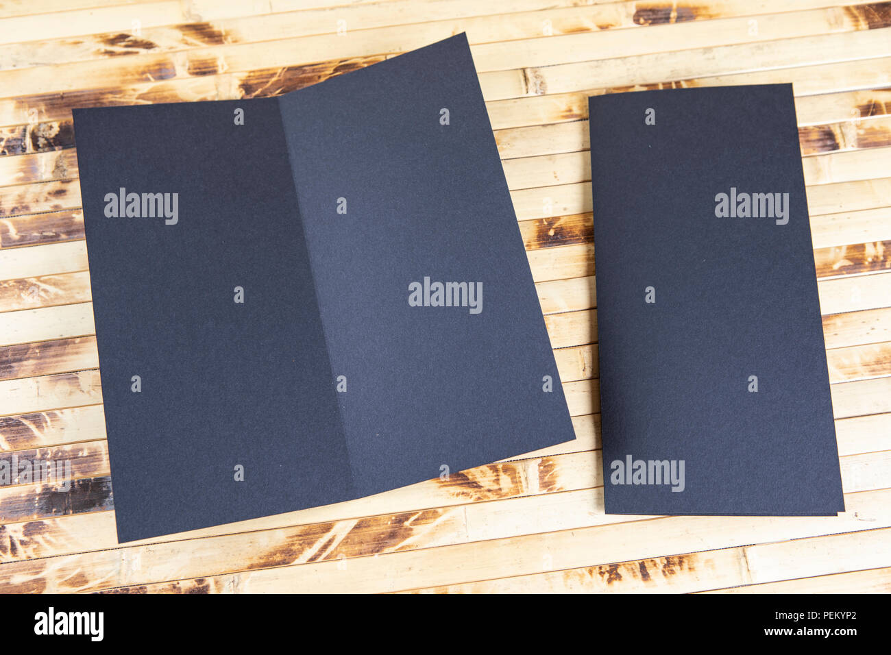 Mockup of black booklet on bamboo background Stock Photo - Alamy