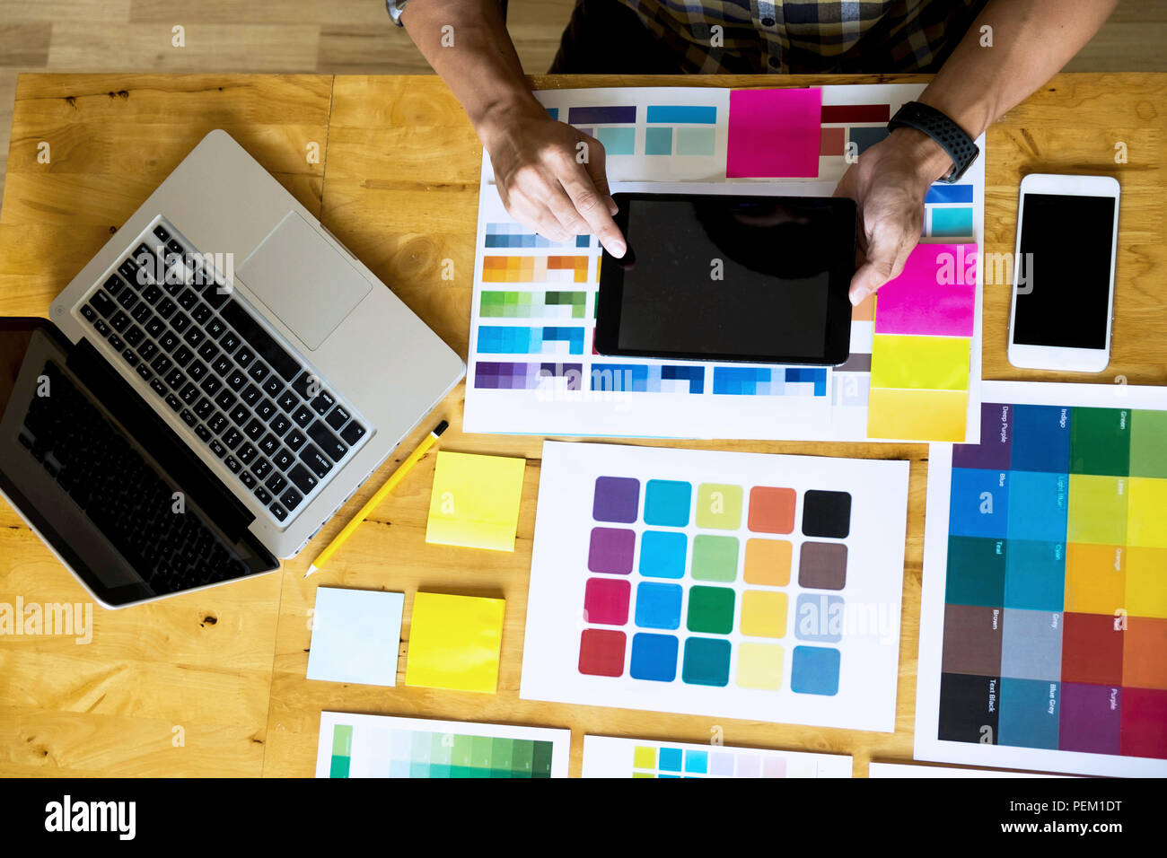 Graphic designers use the tablet to choose colors from the color bar ...
