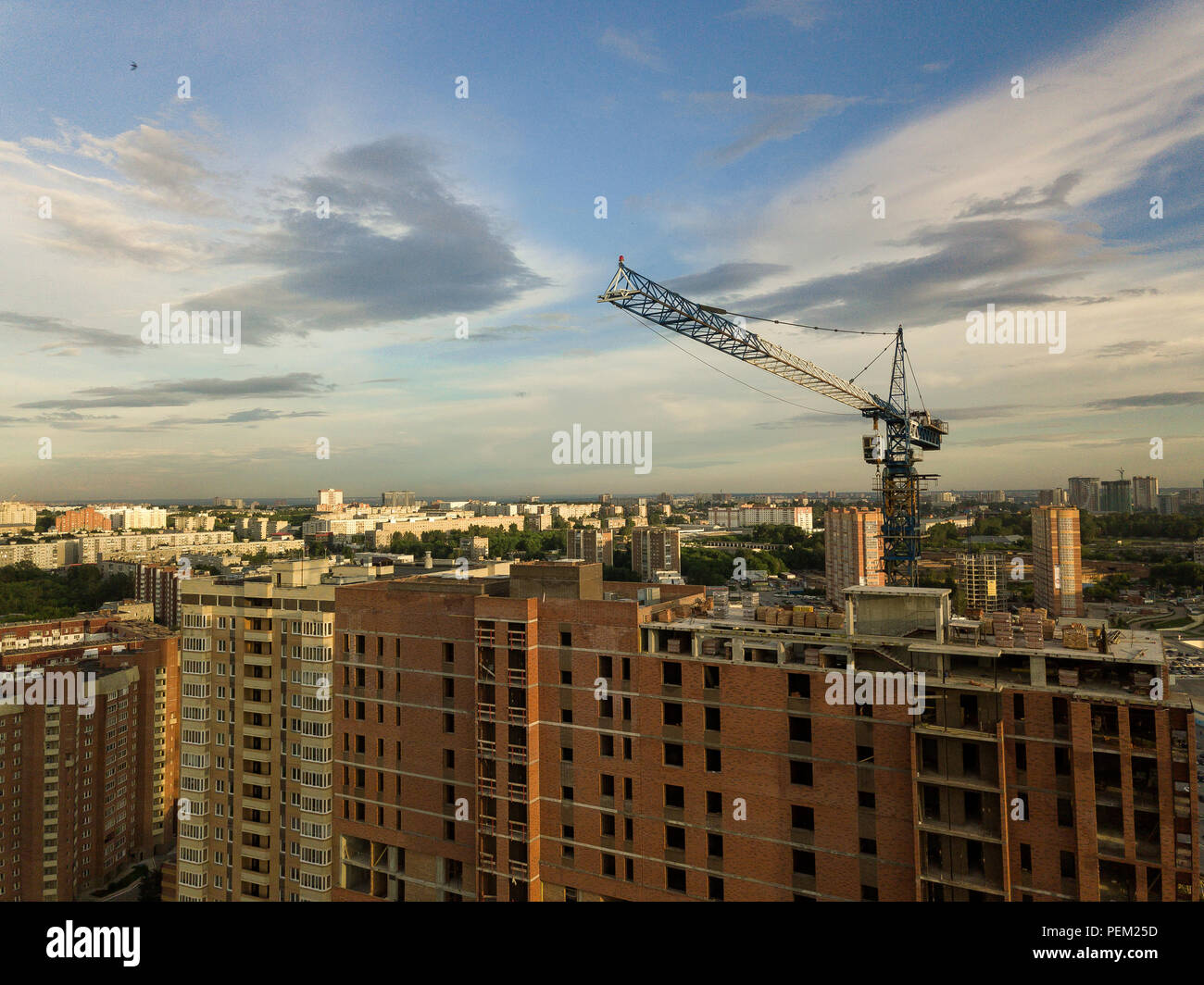 Aerial view of a new modern house under construction with a blue tower ...