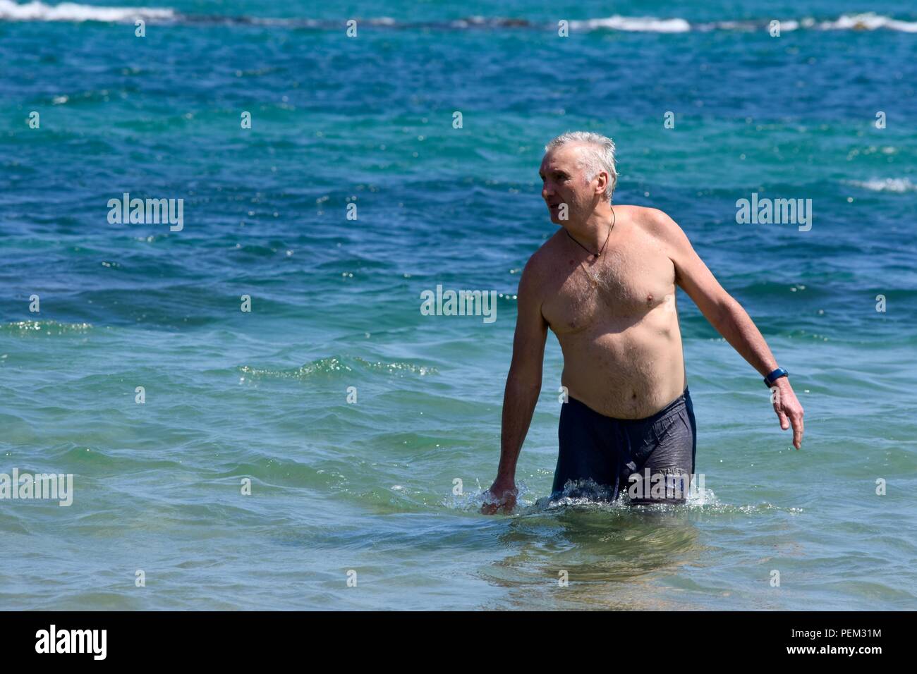 Man coming out of the water after a long swim hi-res stock photography ...