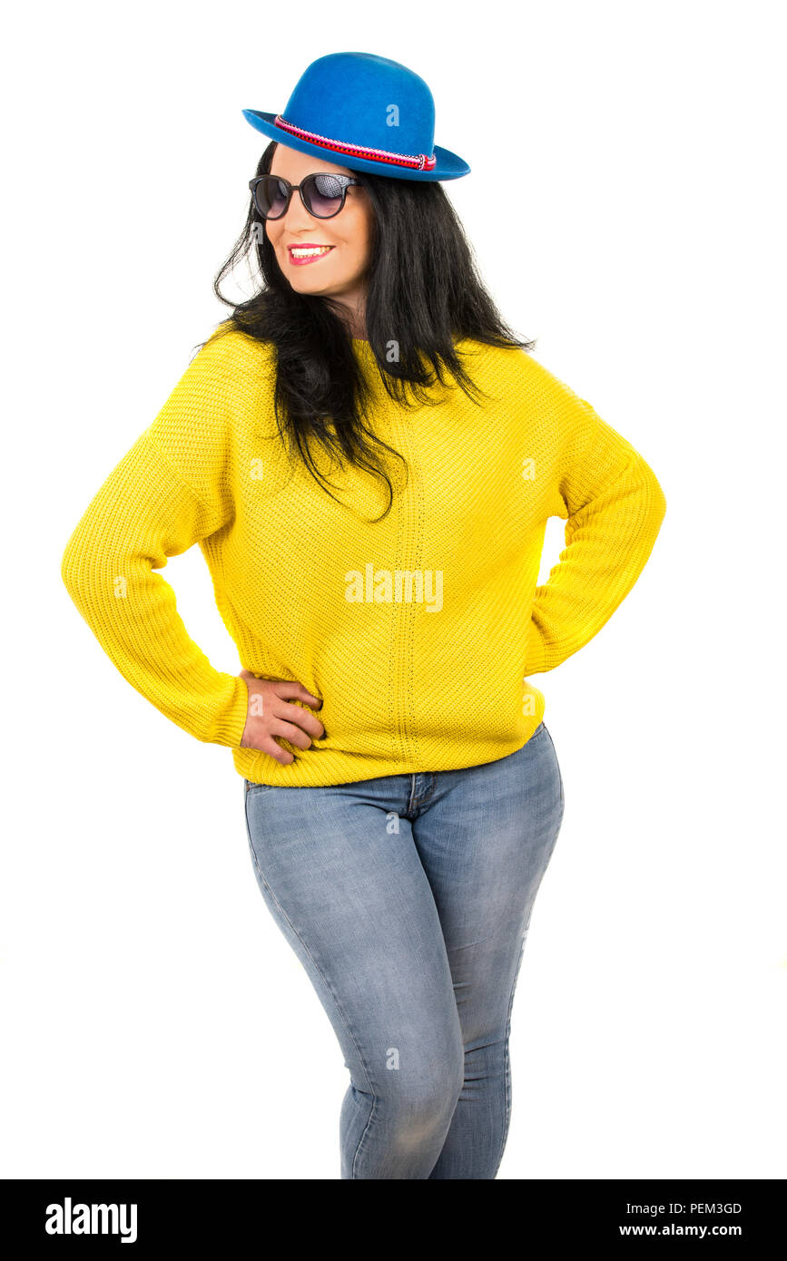 Happy smiling brunette woman with blue wool hat and sunglasses isolated ...