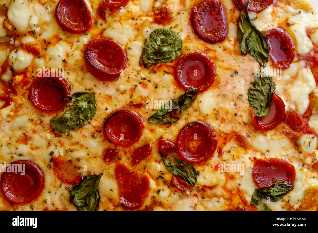 Fresh hot homemade basil and pepperoni pizza Stock Photo - Alamy