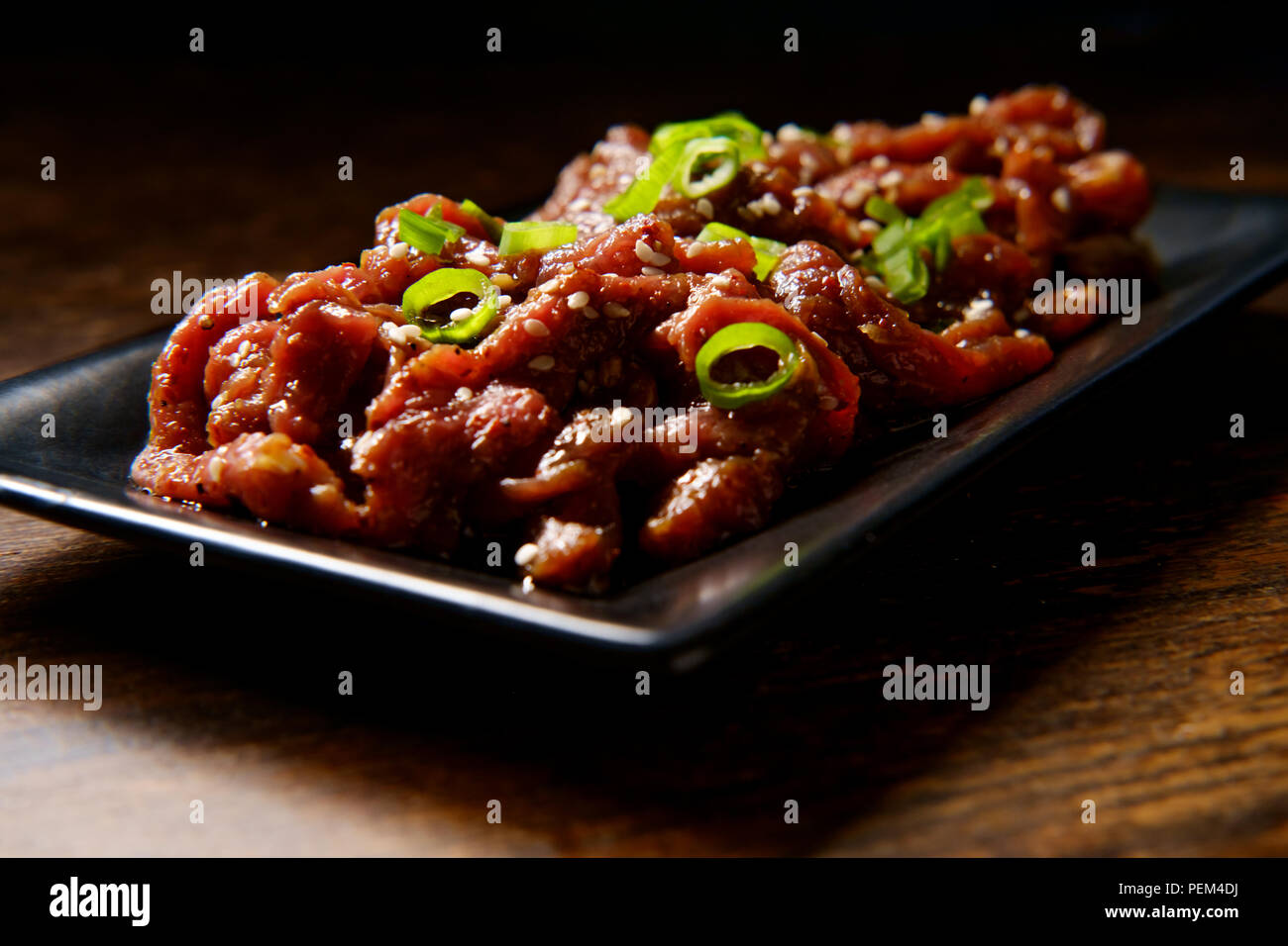 Raw marinating Korean BBQ beef Bulgogi in dark moody lighting Stock ...
