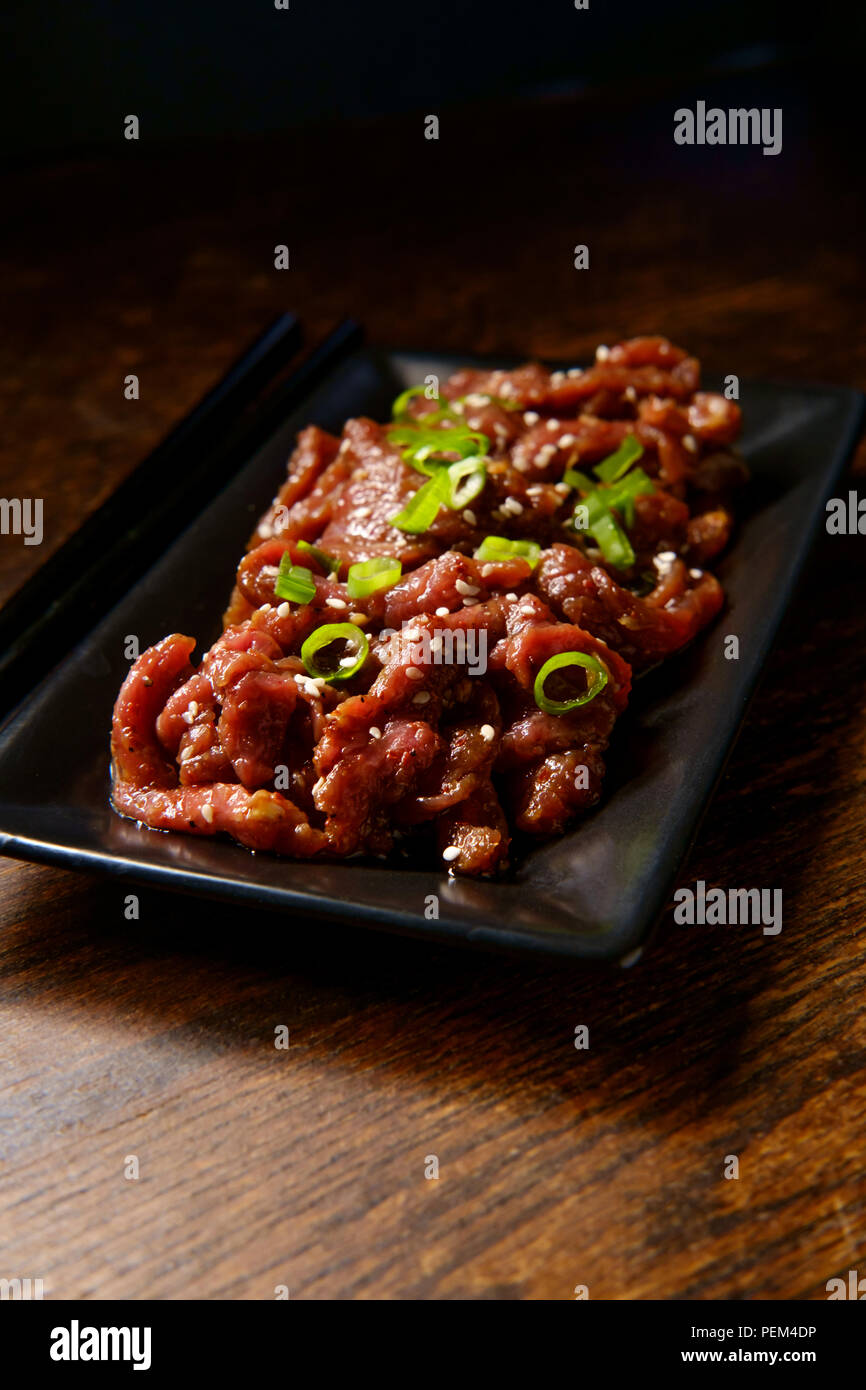 Raw marinating Korean BBQ beef Bulgogi in dark moody lighting Stock ...