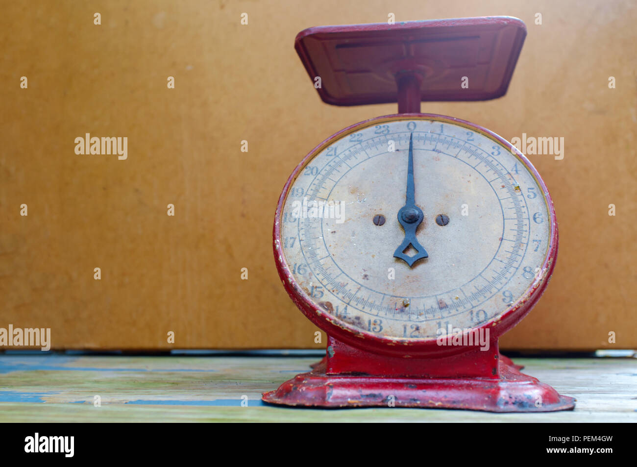 Old fashioned red antique weight measuring scale Stock Photo - Alamy