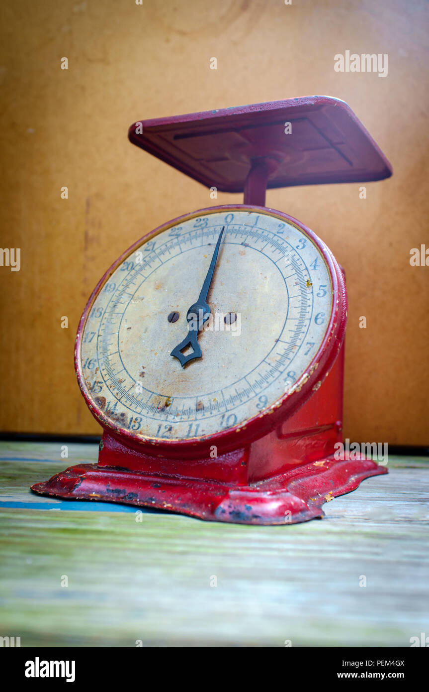 Old fashioned red antique weight measuring scale Stock Photo - Alamy