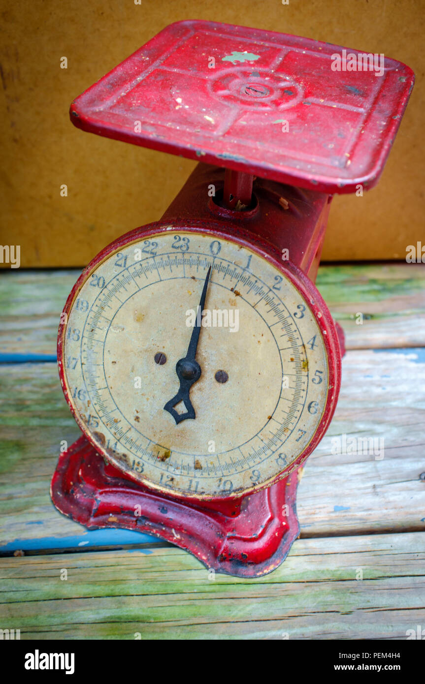 Old fashioned red antique weight measuring scale Stock Photo - Alamy