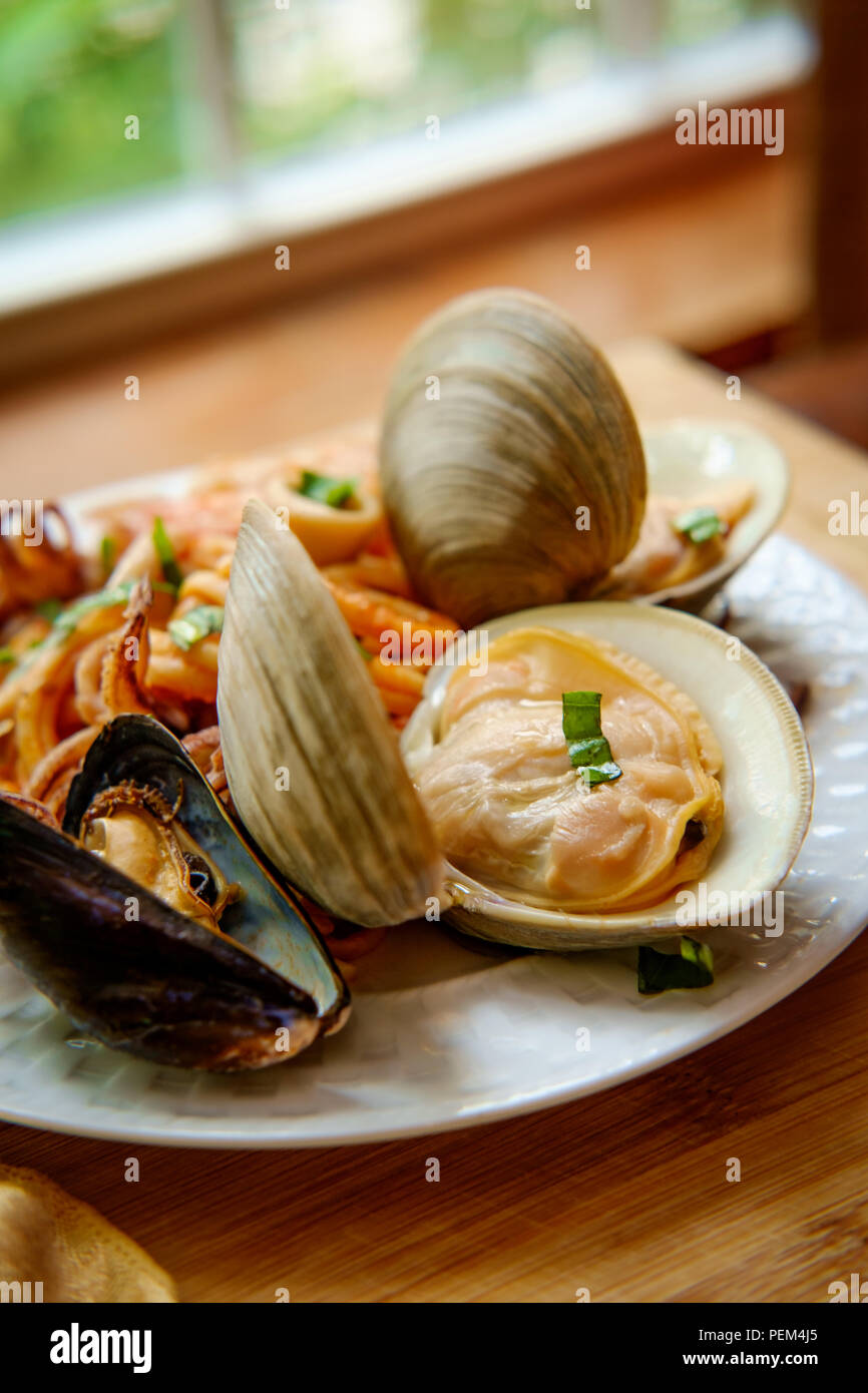 Italian seafood pasta pescatore with clams mussels and squid Stock ...
