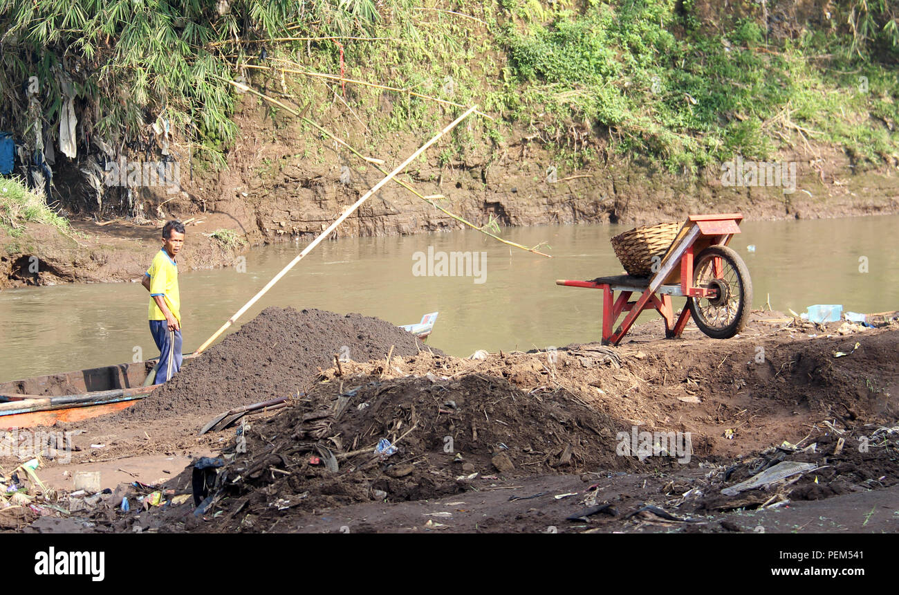 River sand miner working on barge, Citarum River, Bandung, Indonesia ...